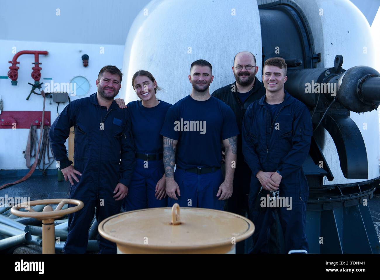 Crew members of the weapons department pose for a photo after a MK-75 ...
