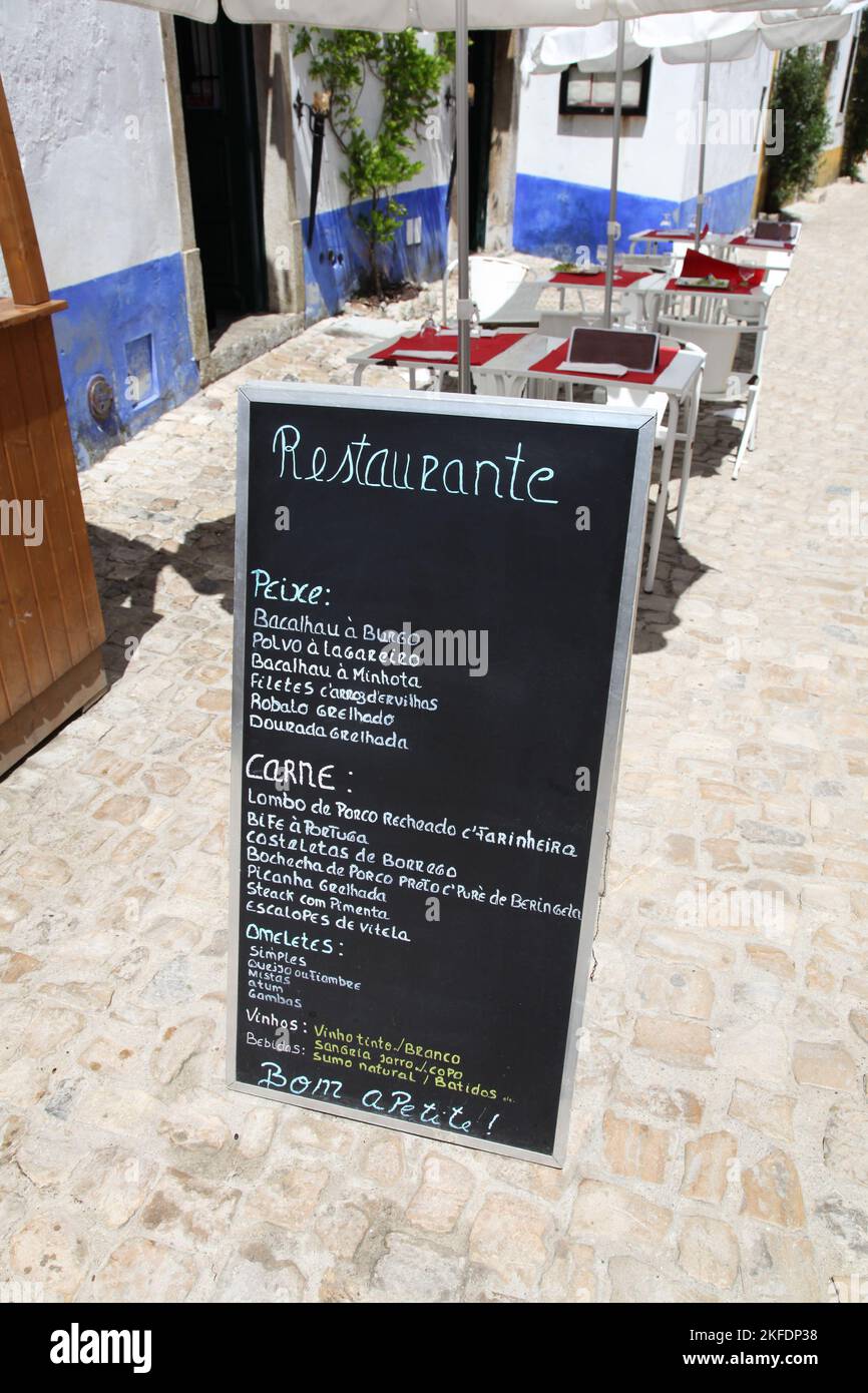 Streetside restaurant dining with blackboard menu in Portuguese ...