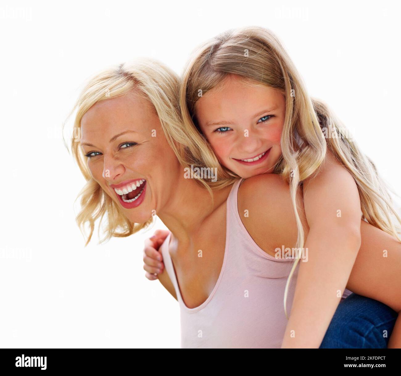 Mother giving piggyback to her daughter. Portrait of mother giving ...
