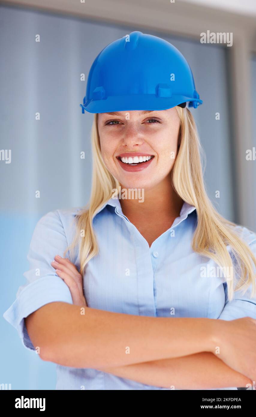 Female architect standing with hands folded. Portrait of female ...