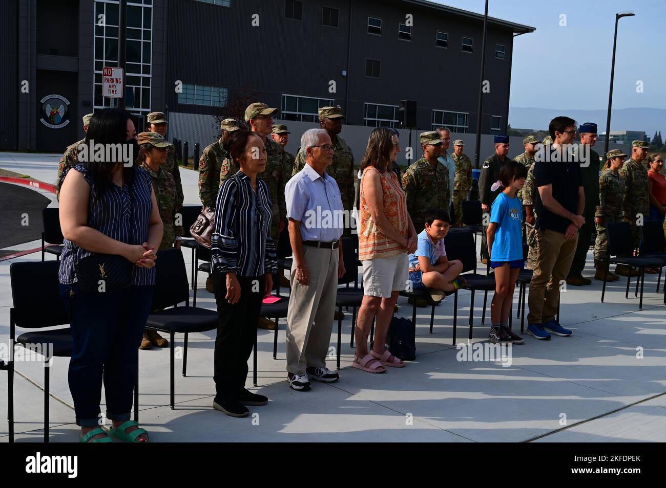 Friends, family and fellow Airmen stand during the Air Force song at ...