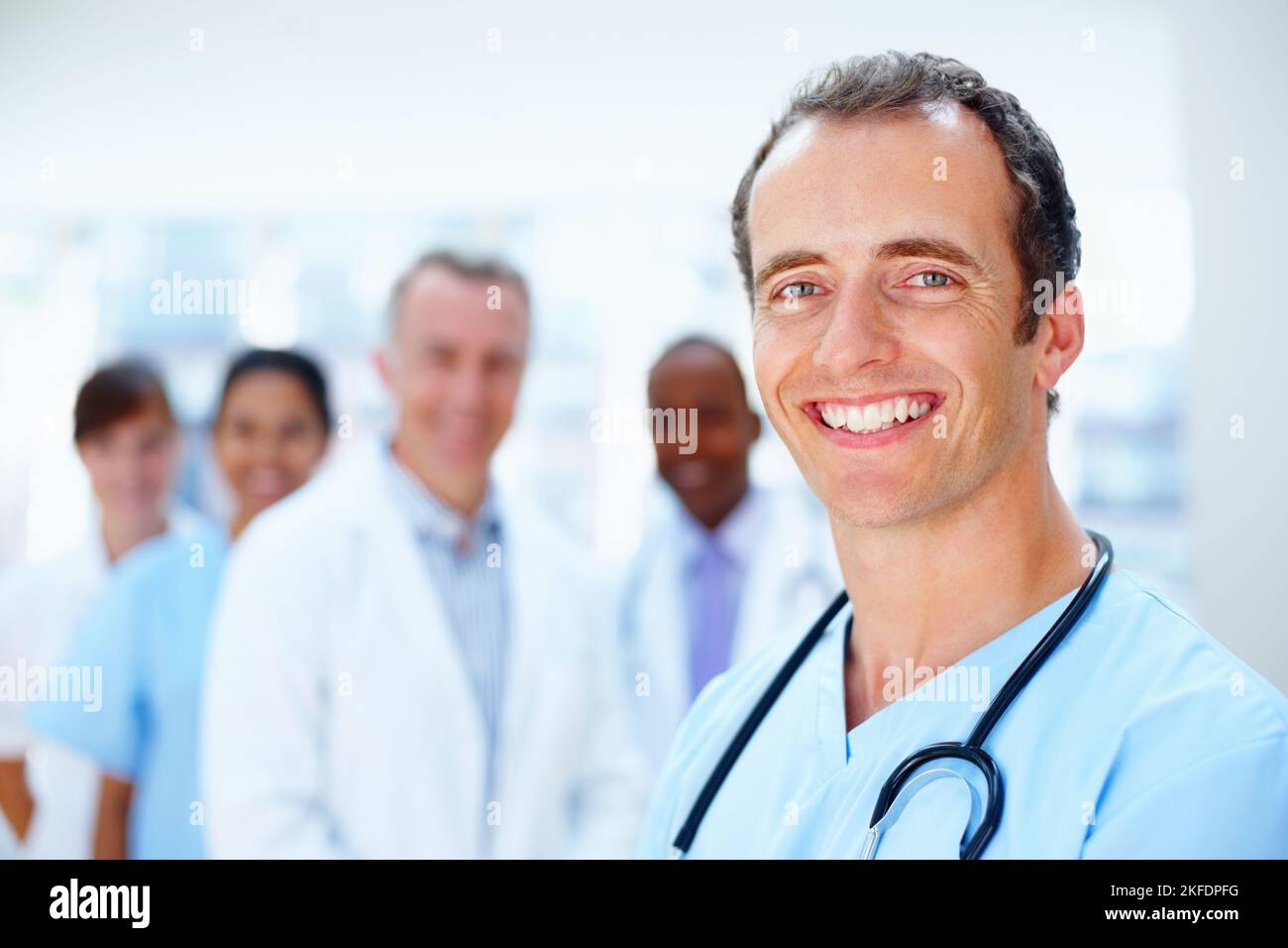 Leading resident. Portrait of happy resident with medical team in ...