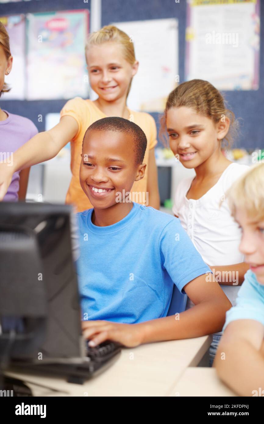 Playing computer games with friends. A multi-ethnic group of school ...