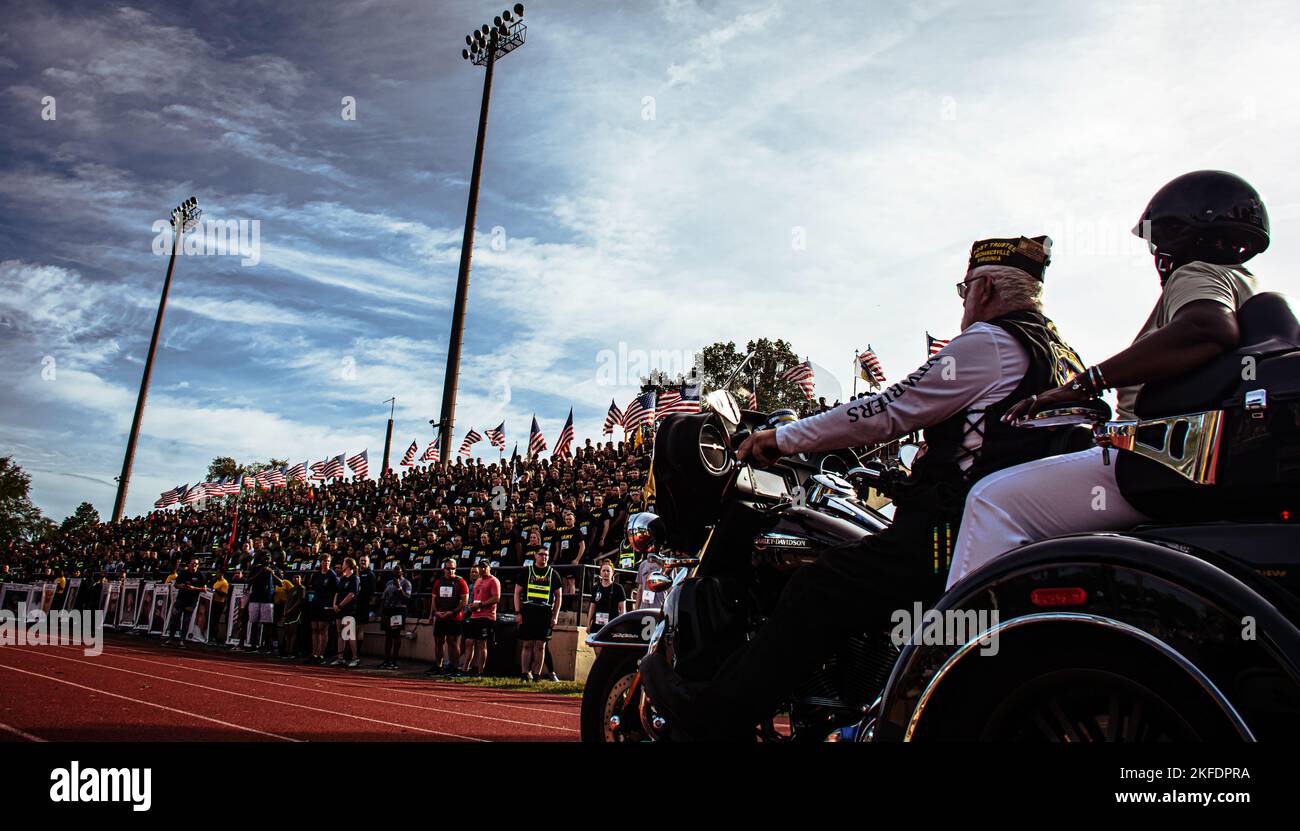 A Veterans of Foreign Wars motorcycle rider leads a procession of Gold ...