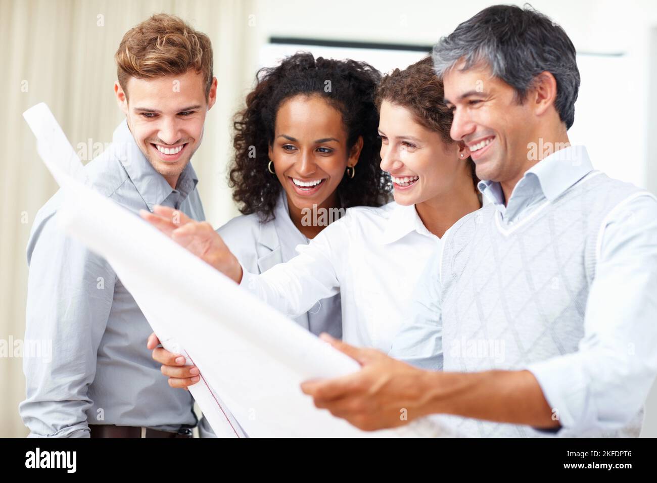 Business people discussing with blueprints. Portrait of female leader ...