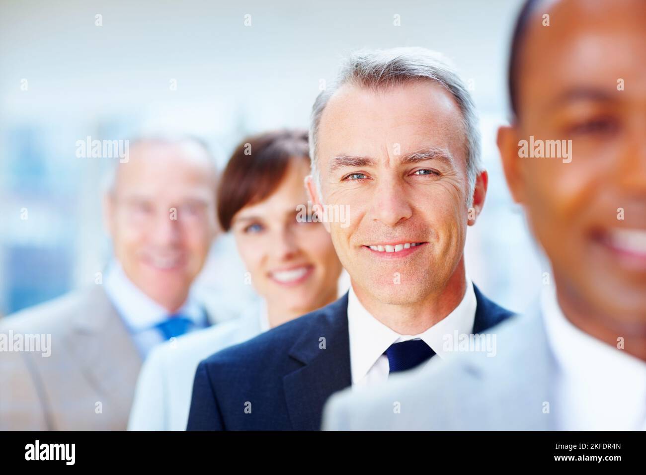 Senior executive with team. Focus on male Business man with colleagues ...