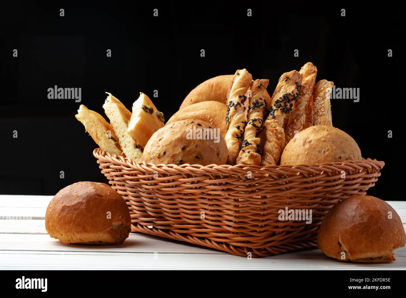 Bakery products in straw bread basket on wooden table Stock Photo - Alamy