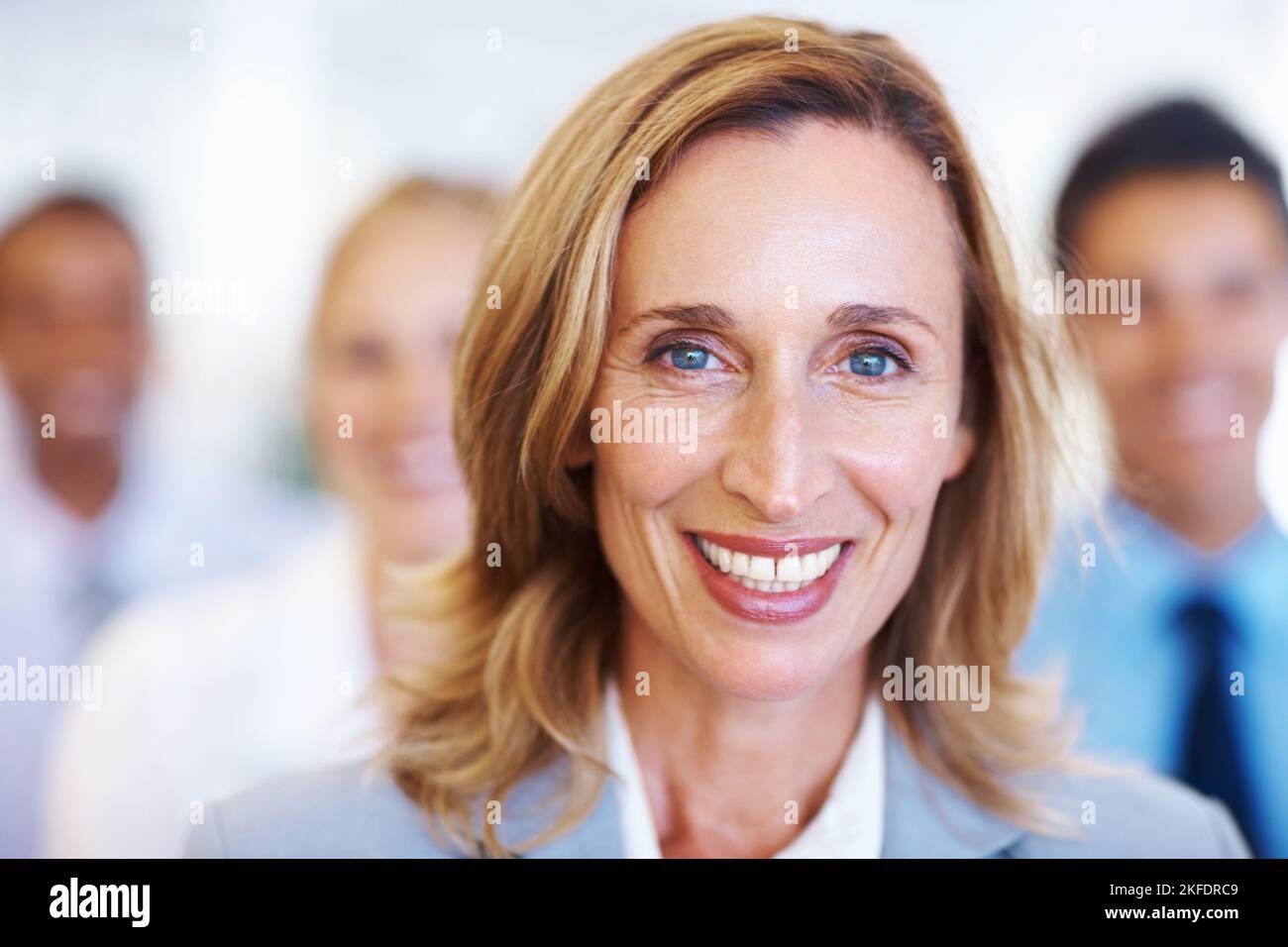 Mature female executive with team in seminar. Closeup of mature female ...