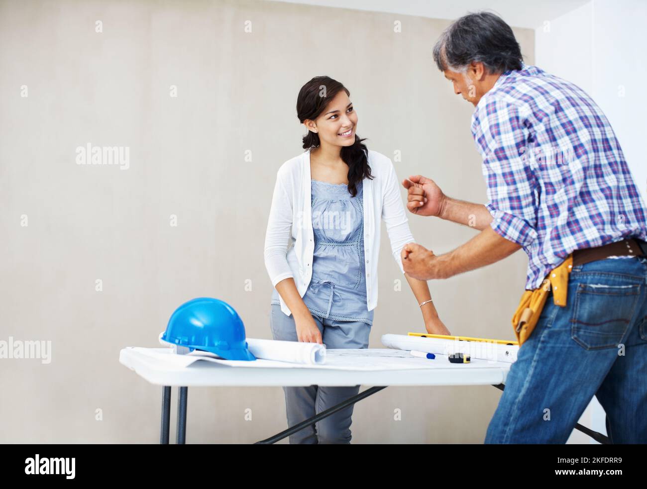 Pretty woman having discussion with contactor. Mature contractor ...