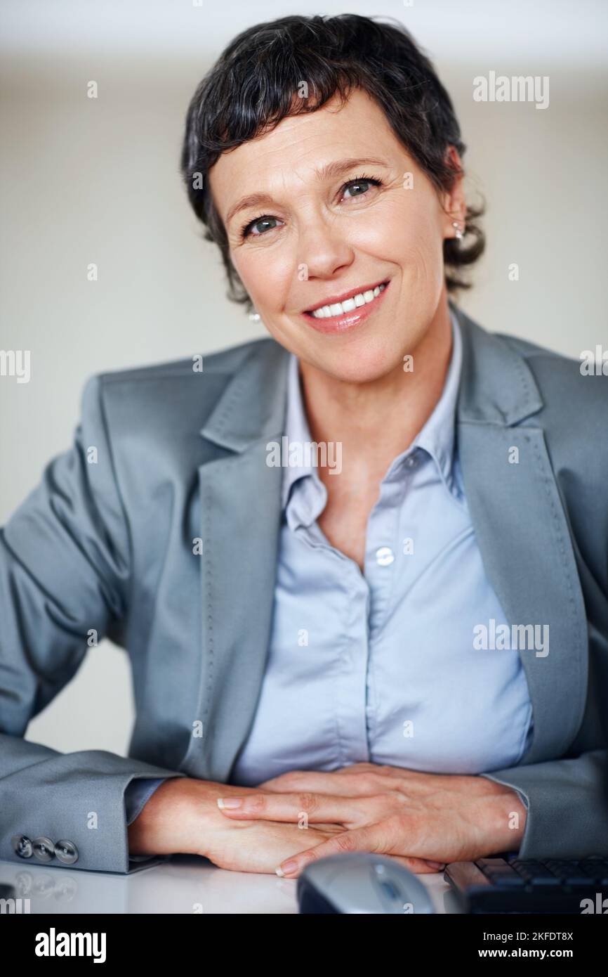 Dedicated business woman. Portrait of dedicated business woman smiling ...