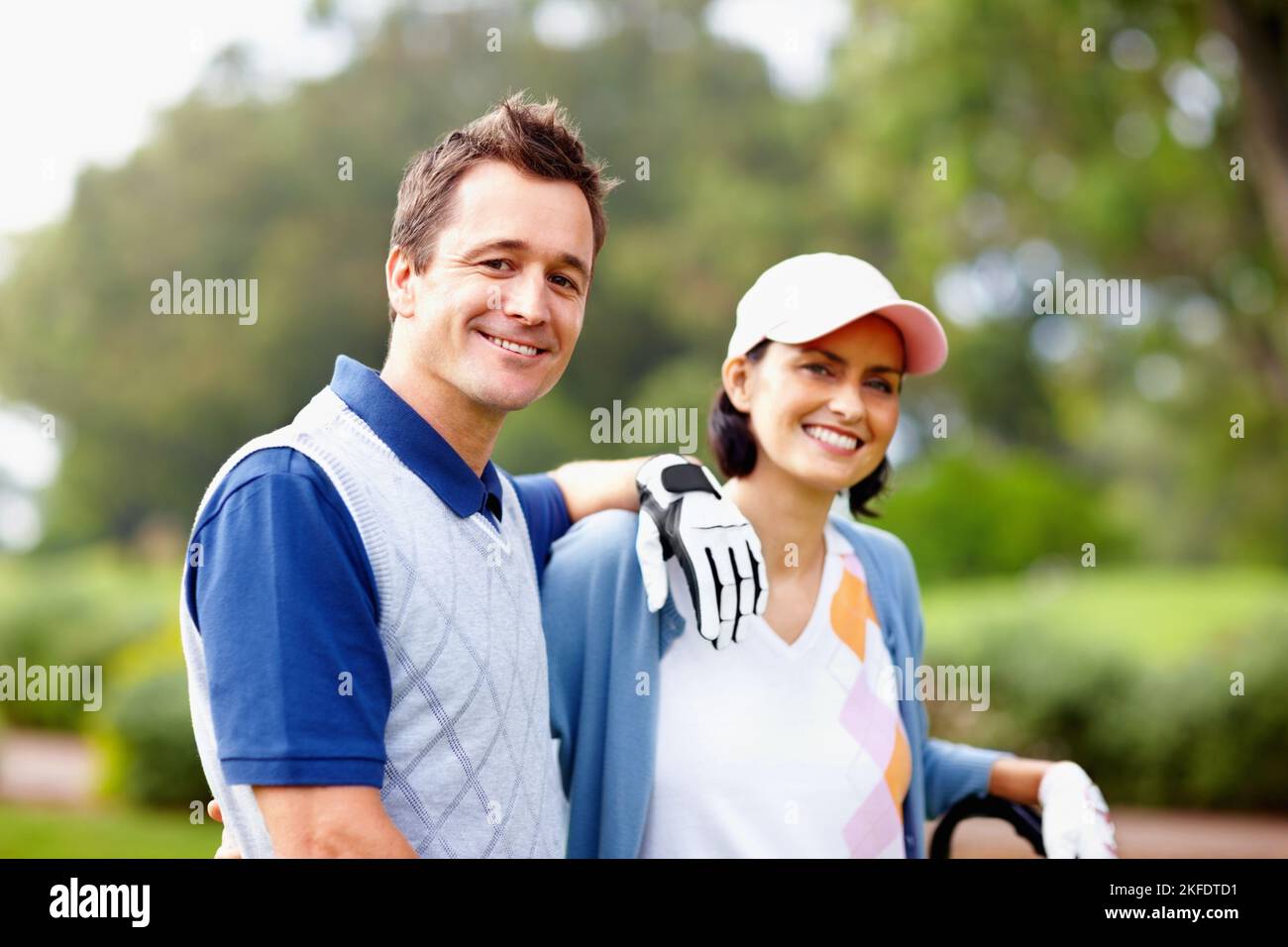 Golfing couple with an attractive smile. Portrait of golfing couple ...