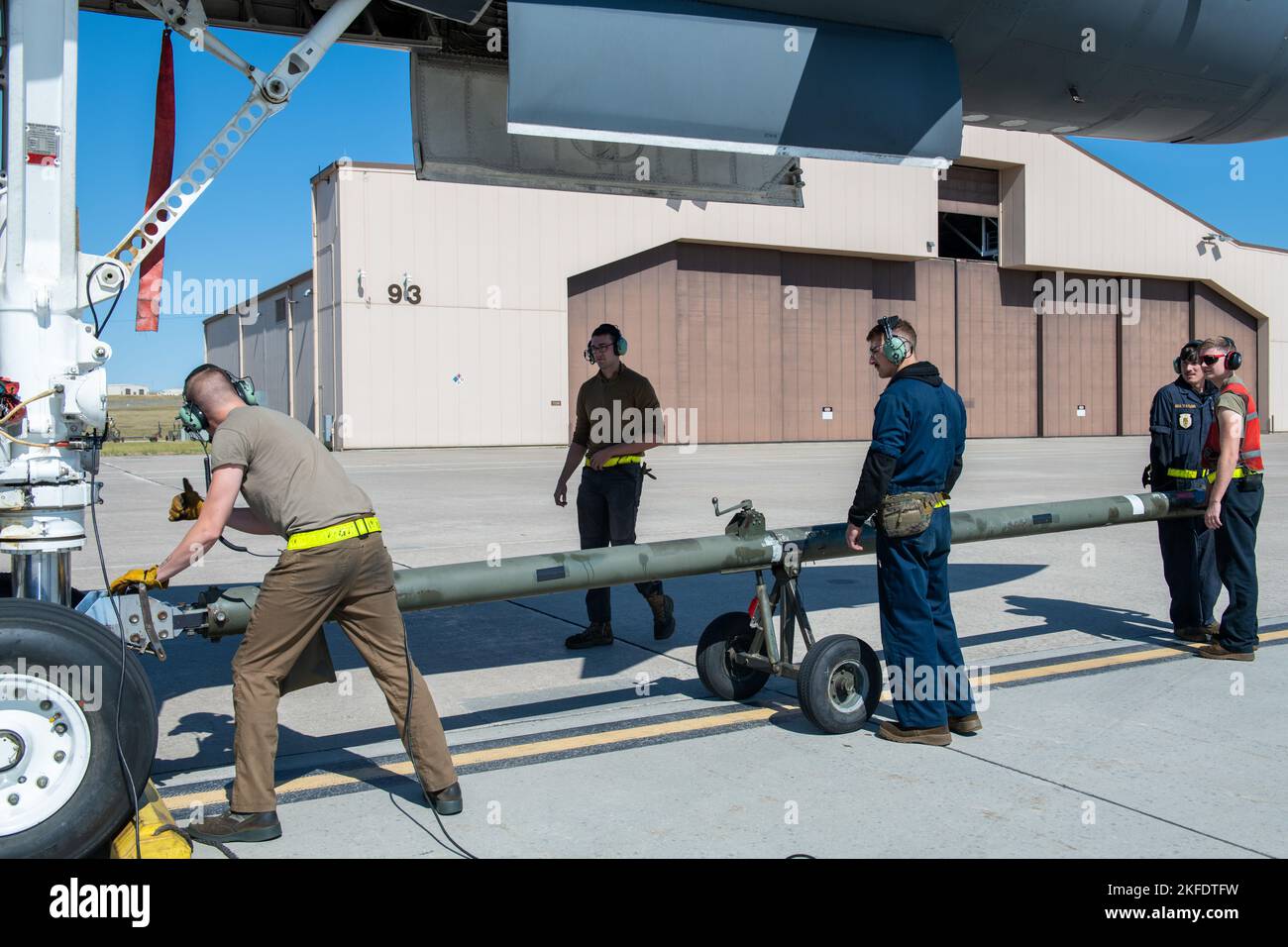 Maintainers from the 28th Aircraft Maintenance Squadron attach a tow ...