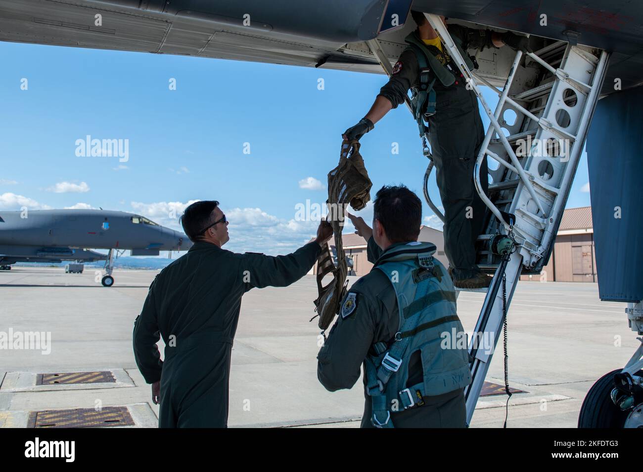 Aircrew assigned to the 37th Bomb Squadron unload equipment from a B-1B ...