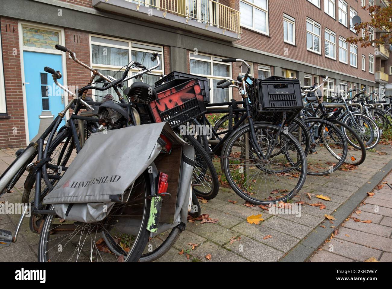 Bicycles with load carrying crates and racks parked outside apartments ...
