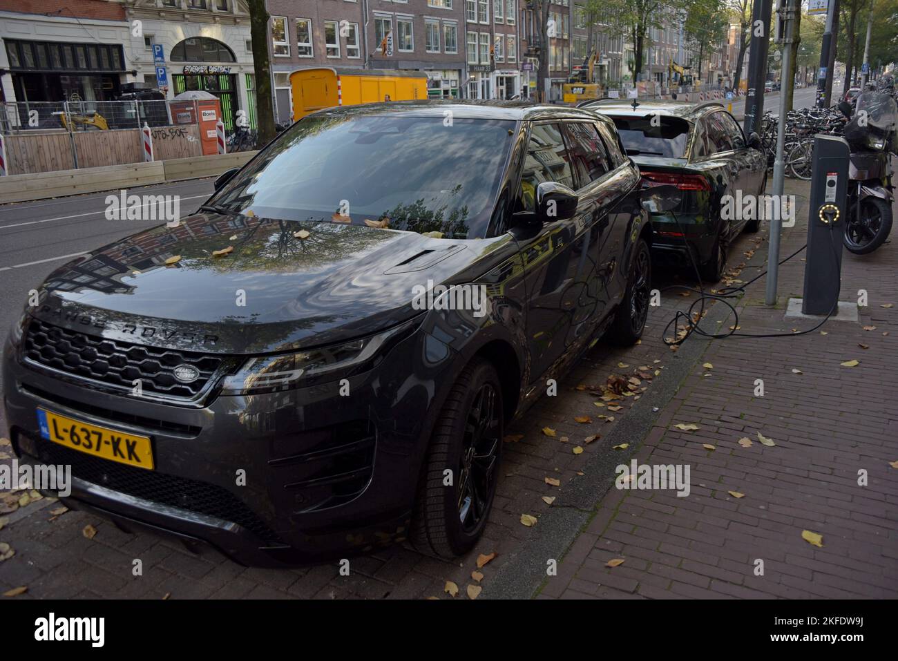 EV electric Range rover and Audi cars charging at an on street charging ...