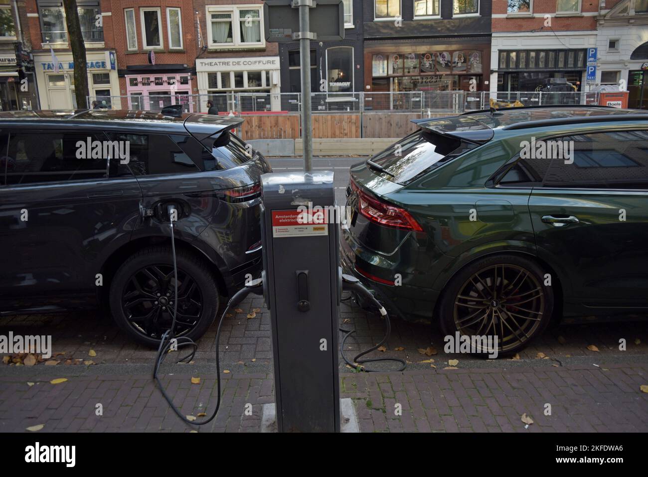 EV electric Range rover and Audi cars charging at an on street charging ...