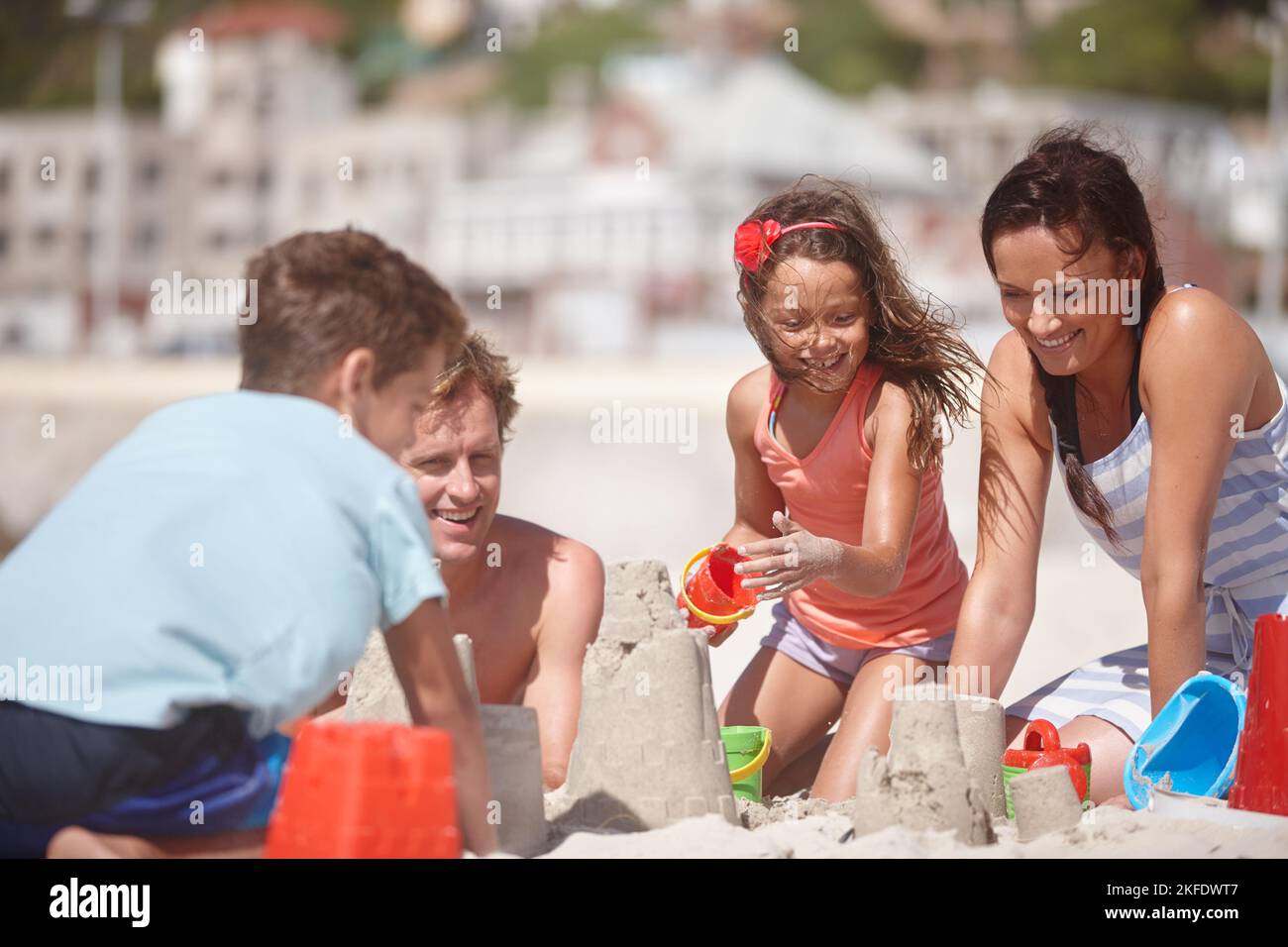 Working as a team on this one. a happy family building sandcastles ...
