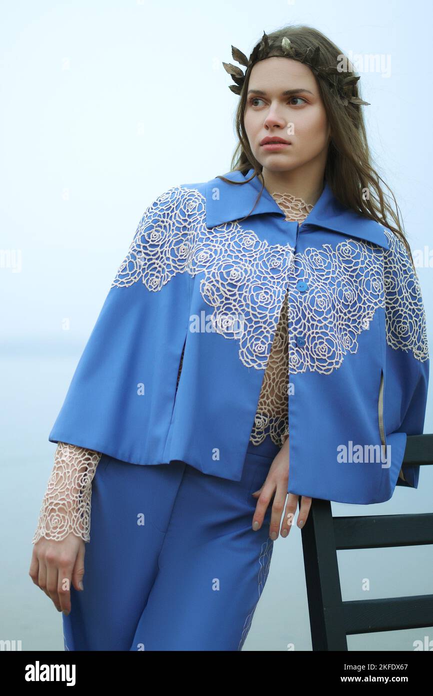 Fashion model leaning against a chair in a cloudy day on a beach Stock ...