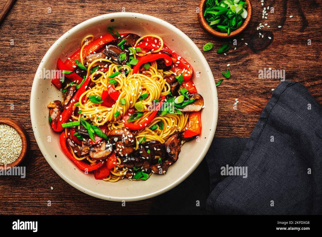 Vegan Stir fry noodles with vegetables, paprika, mushrooms, chives and ...