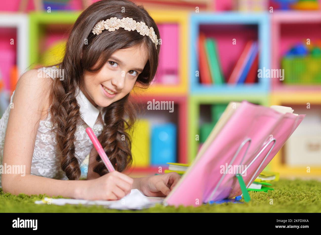 Portrait of cute little girl study at home Stock Photo - Alamy