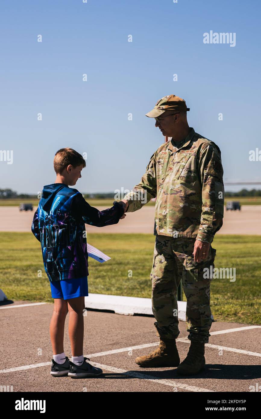U.S. Air Force Col. Gordon Meyer presents the Home Front Hero Award to ...