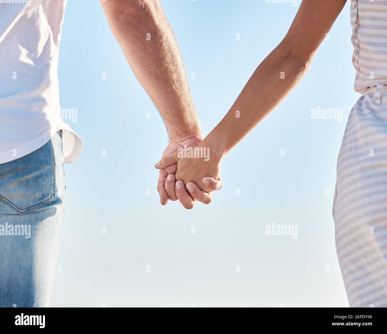 Couple holding hands, blue sky and love together in nature, summer ...
