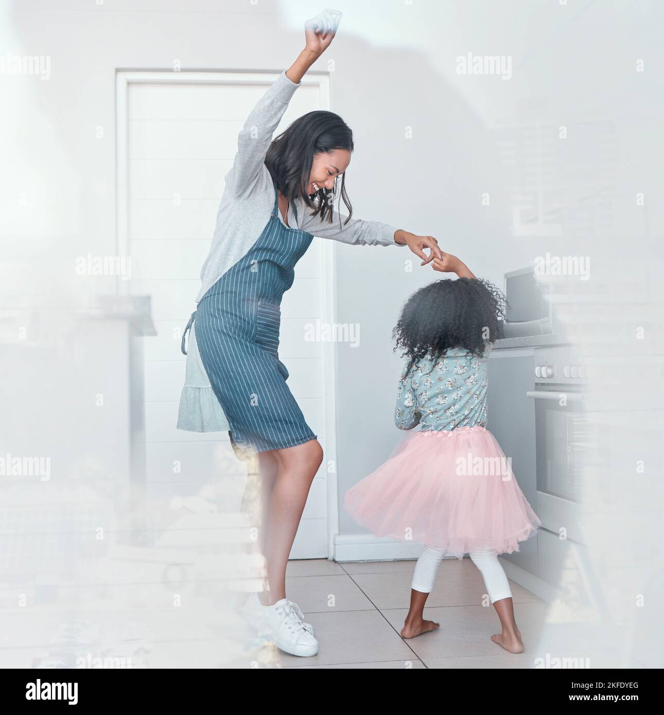 Mother, dance and ballet with her child for fun while cooking or baking ...