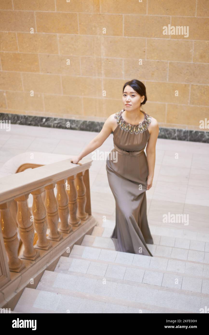 Ascending with poise. Portrait of an elegantly dressed young woman ...