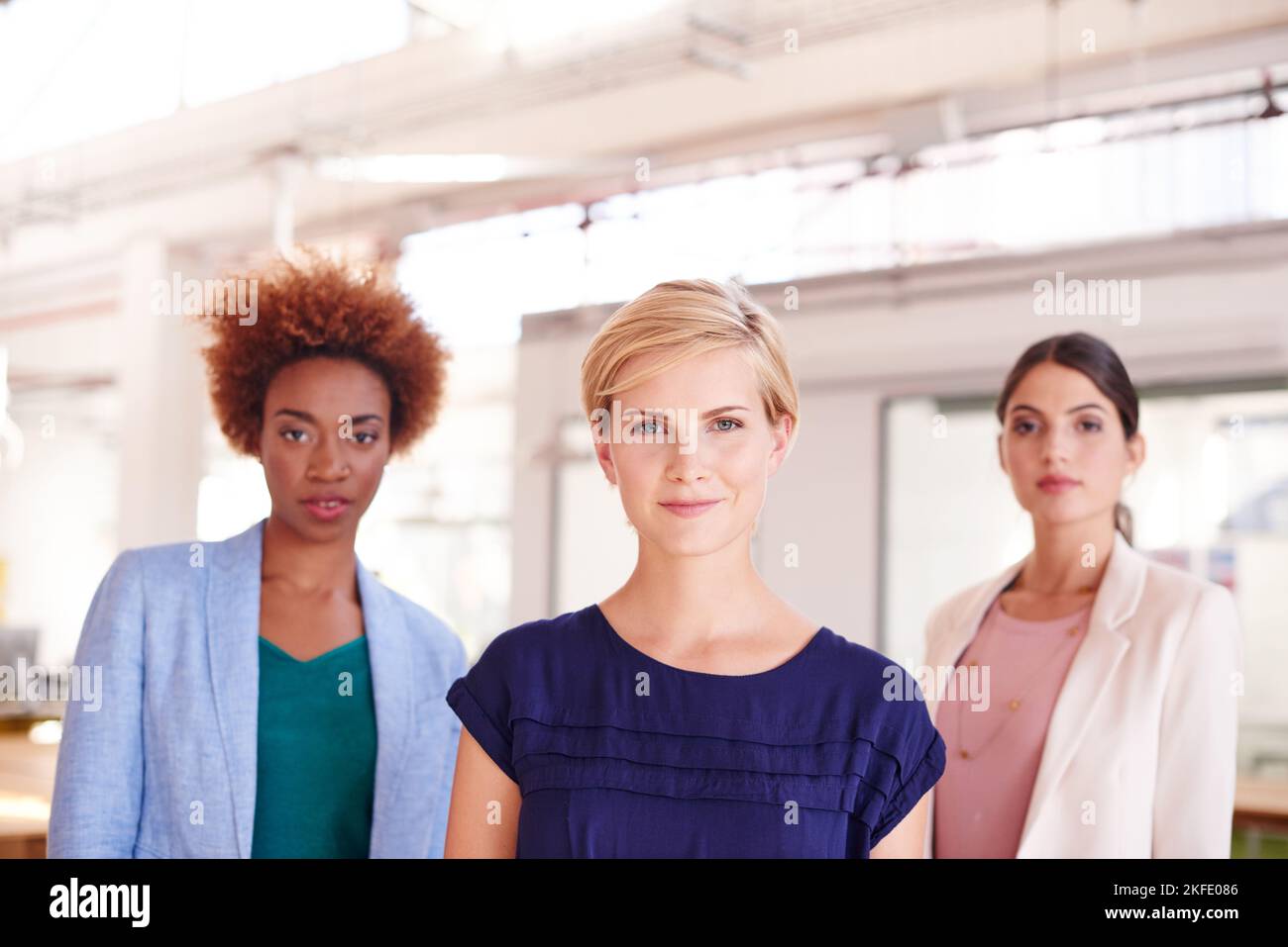 Act like a lady, think like a boss. Portrait of three female coworkers ...