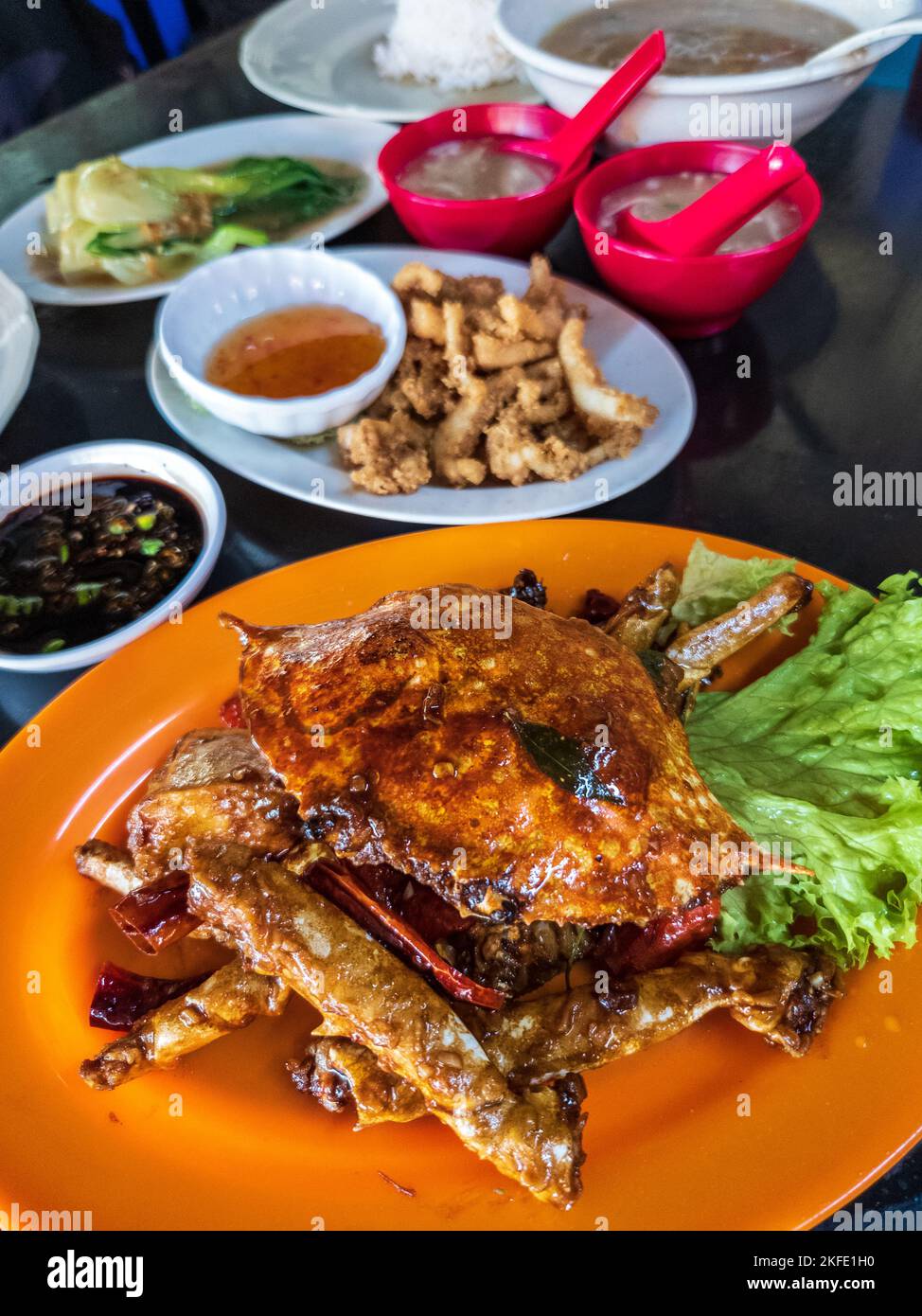 Chilli mud crab served with other Chinese food on the table Stock Photo ...