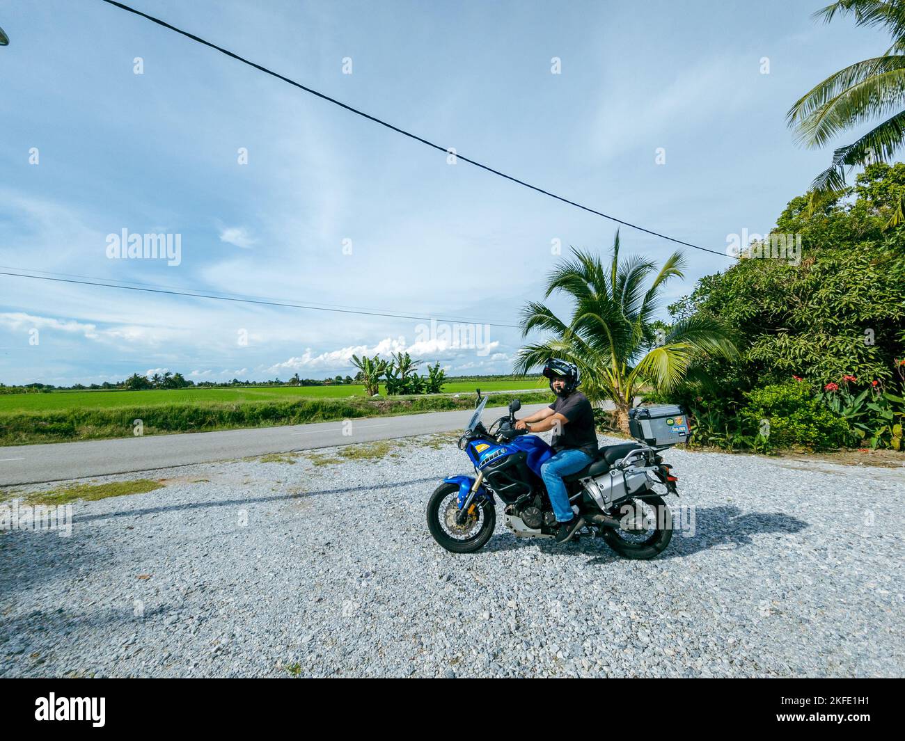 Sekinchan, Malaysia - Oct 5, 2022 Adventure motorcycle traveler going ...
