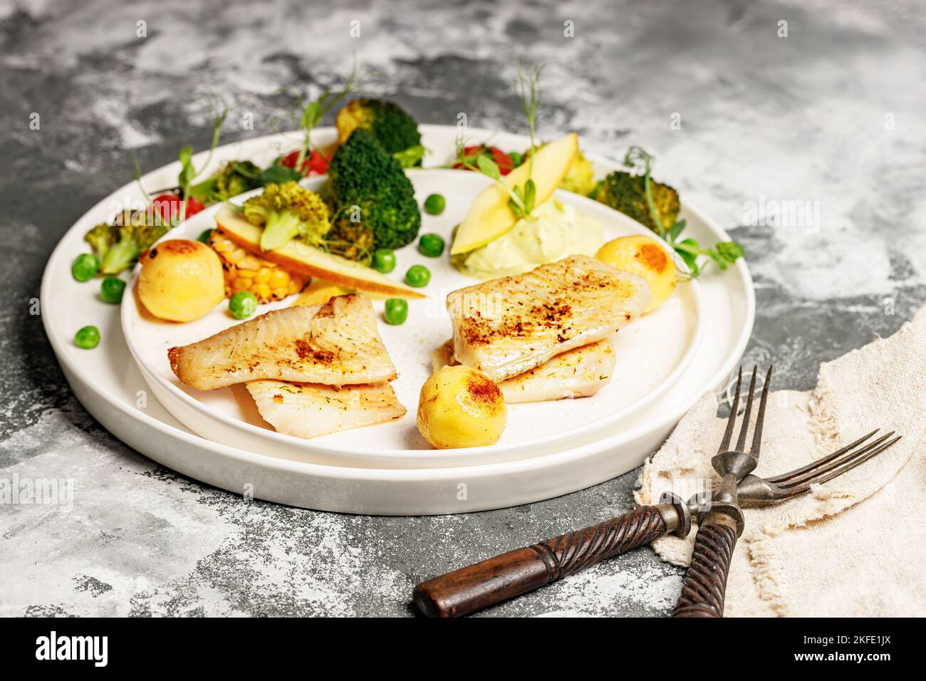 Baked sea fish fillet with vegetables. Tilapia fillet with broccoli ...