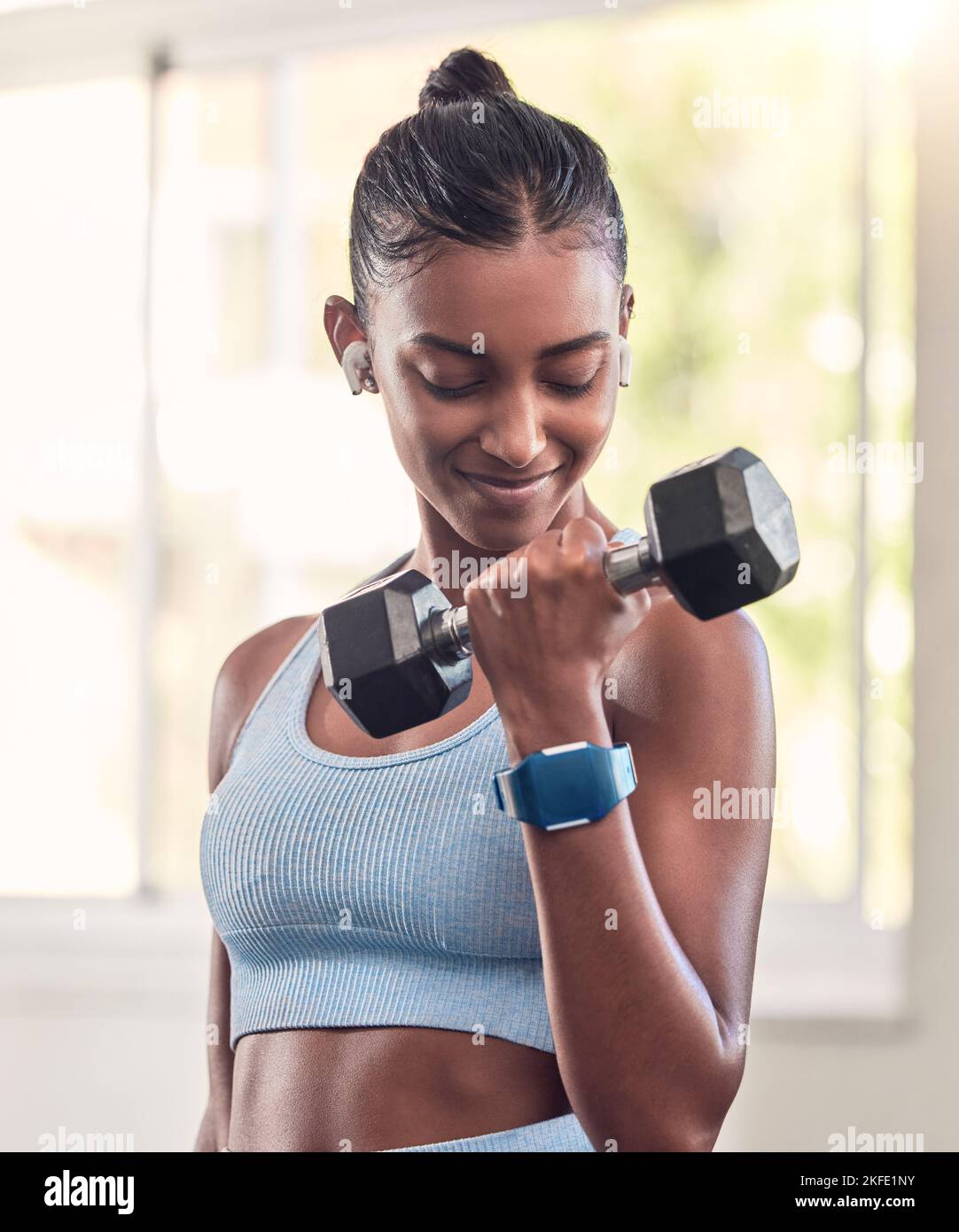 Fitness, exercise and dumbbell with indian woman, earphone and training ...