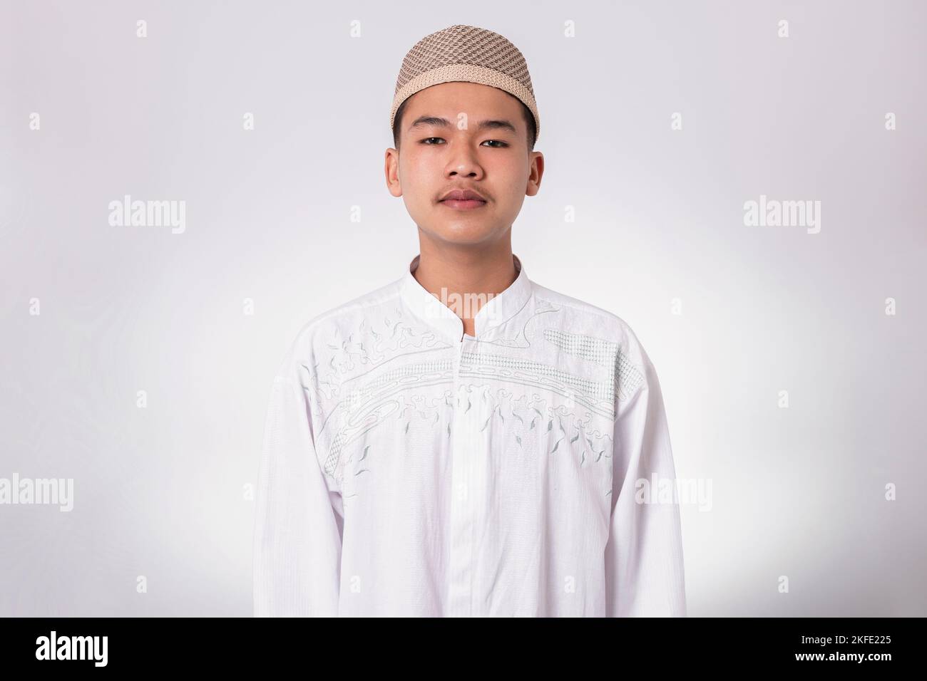 Smiling Asian muslim man happy celebrating Eid Al-Fitr isolated white ...