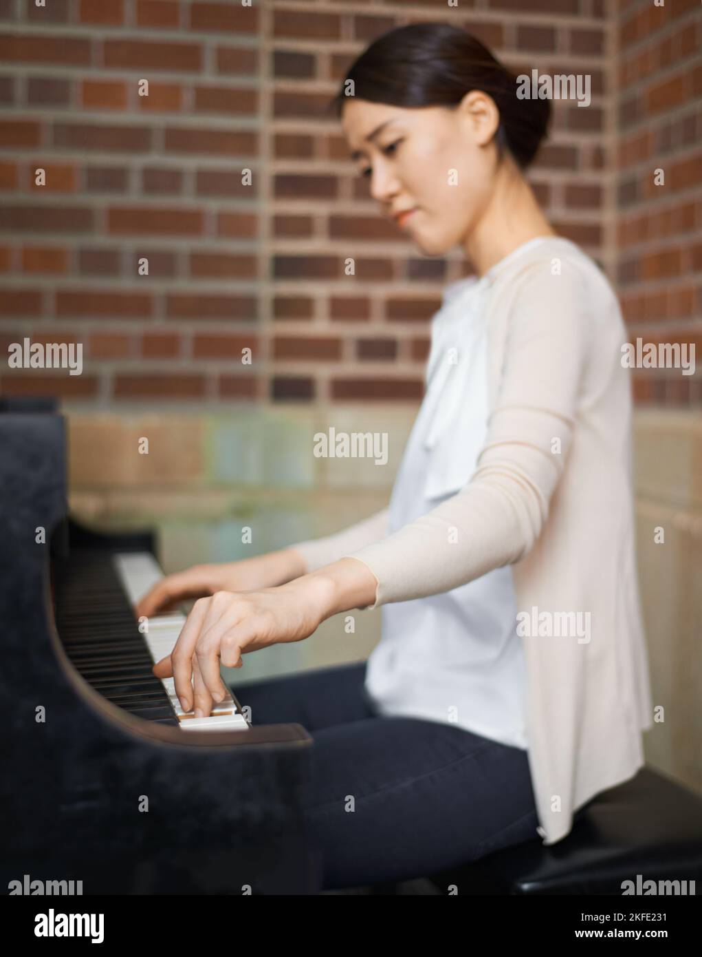 Let the music move you. a young woman dressed elegantly in her home ...