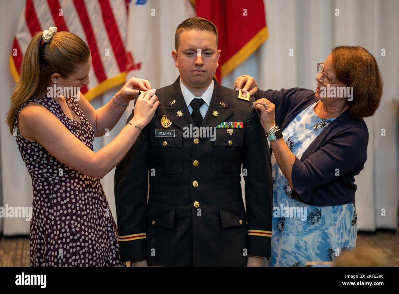 2nd Lt. Trevor McMinn is pinned his new rank by his wife and mother ...
