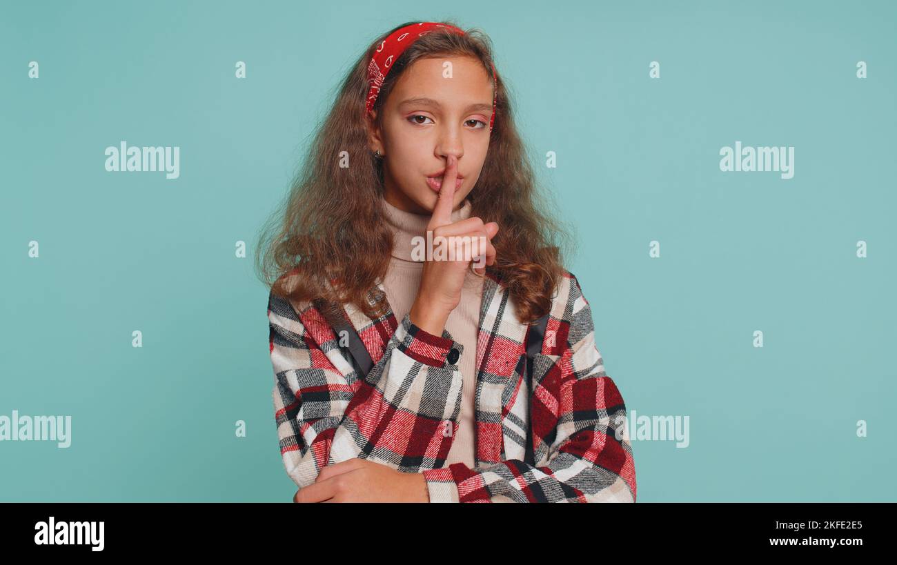 Shh be quiet please. Preteen child girl kid presses index finger to ...