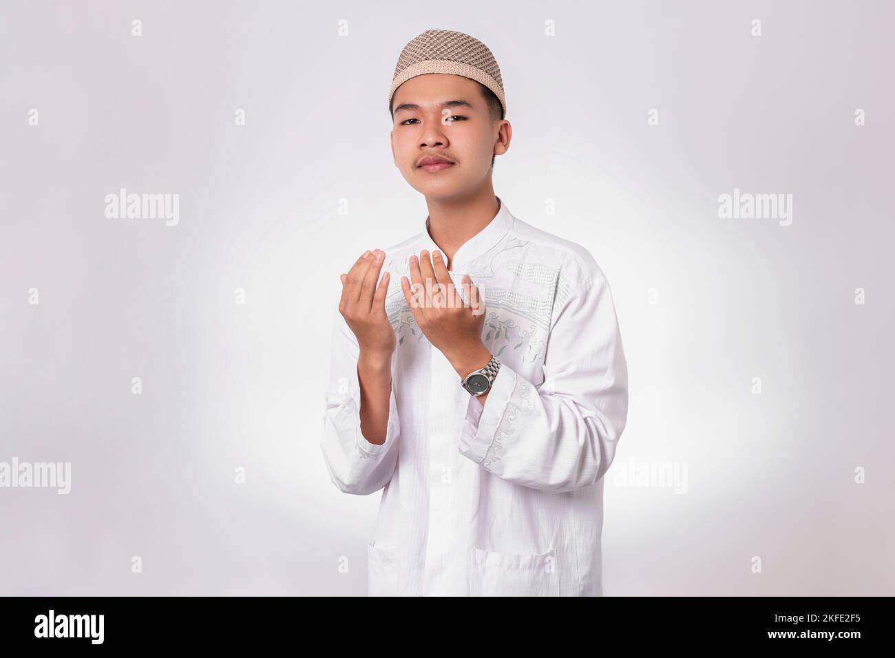 Smiling Asian muslim man happy celebrating Eid Al-Fitr isolated white ...