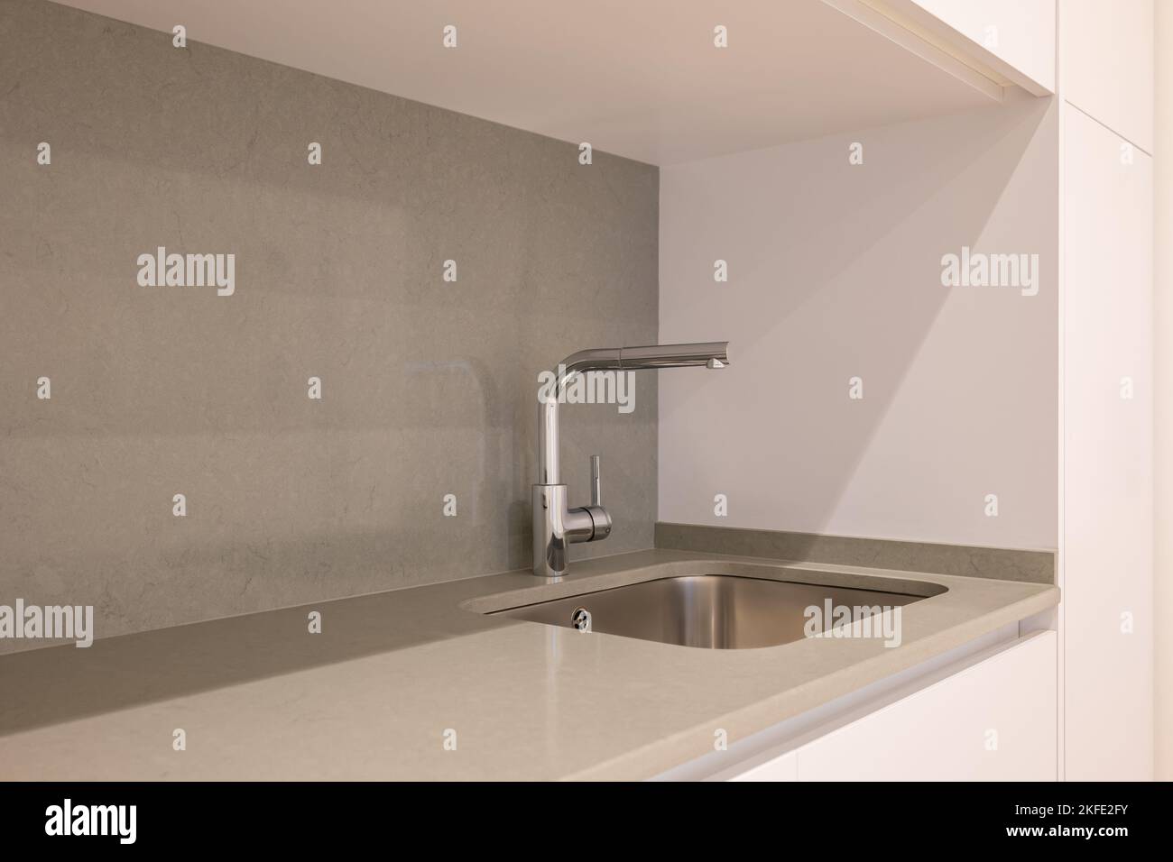 Empty gray kitchen interior with sink and metal faucet Stock Photo - Alamy
