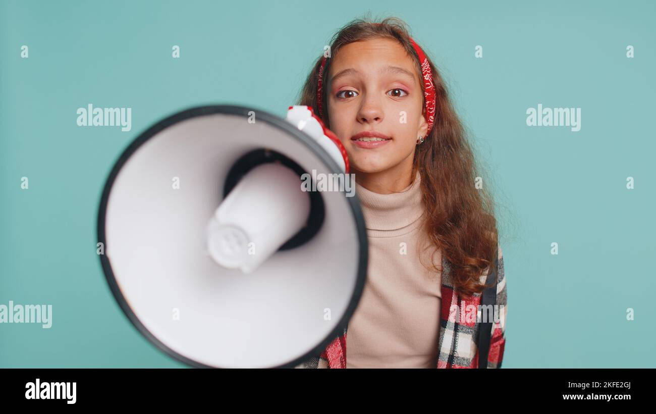 Hurry up. Young teenager child girl kid talking with megaphone ...