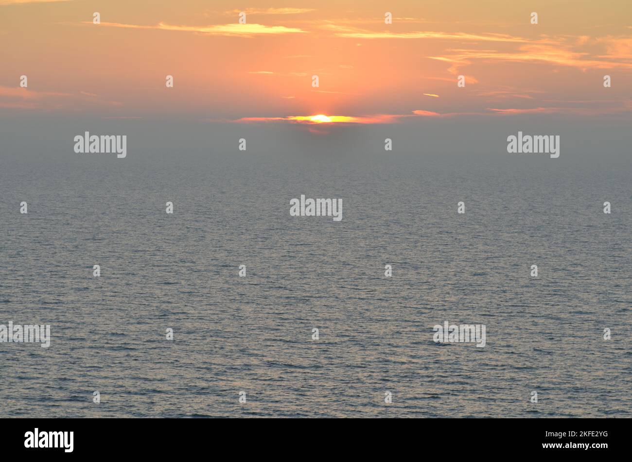 sunset at Sea ocean to horizon colorfull pastell calm Stock Photo - Alamy