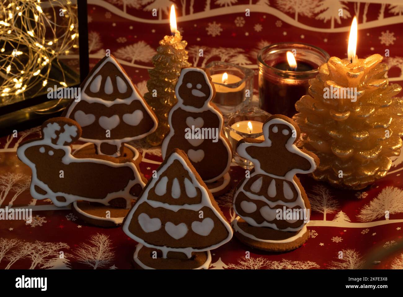 photo of gingerbread and candles standing side by side, natural light ...