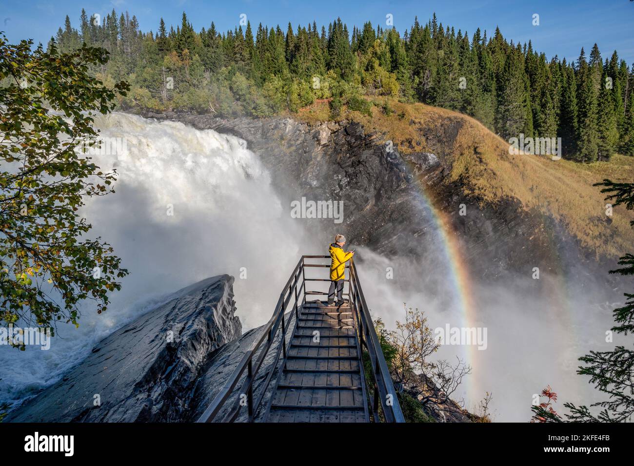 Girls standing on viewpoint bridge at Famous waterfall Tannforsen ...