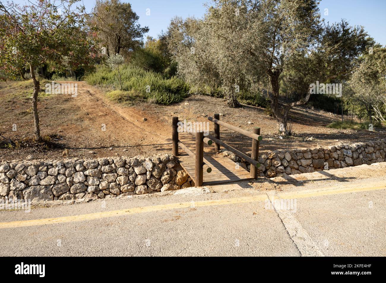 a small wooden bridge in a park Stock Photo - Alamy