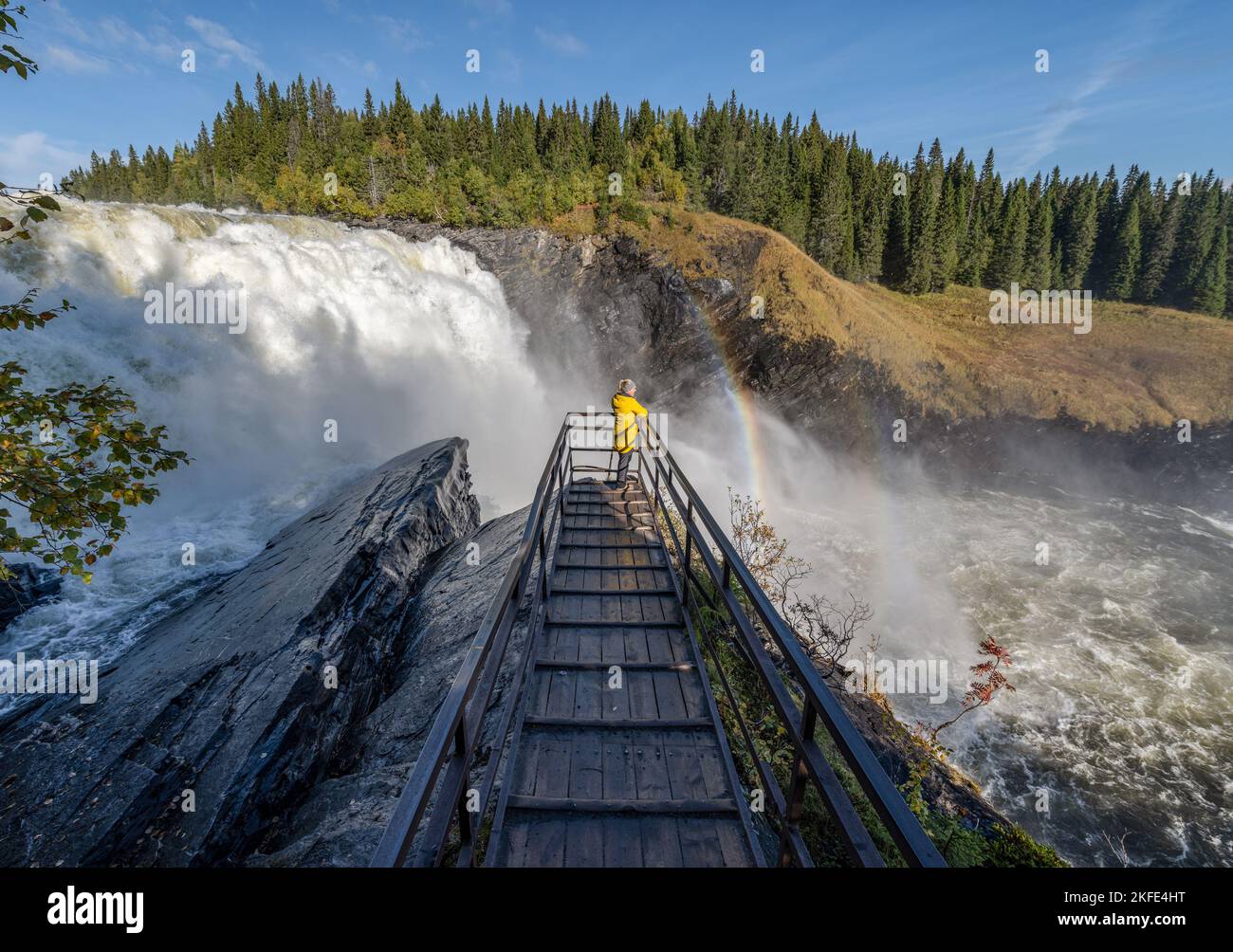Girls standing on viewpoint bridge at Famous waterfall Tannforsen ...