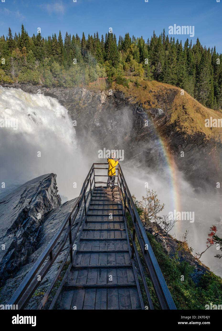 Girls standing on viewpoint bridge at Famous waterfall Tannforsen ...