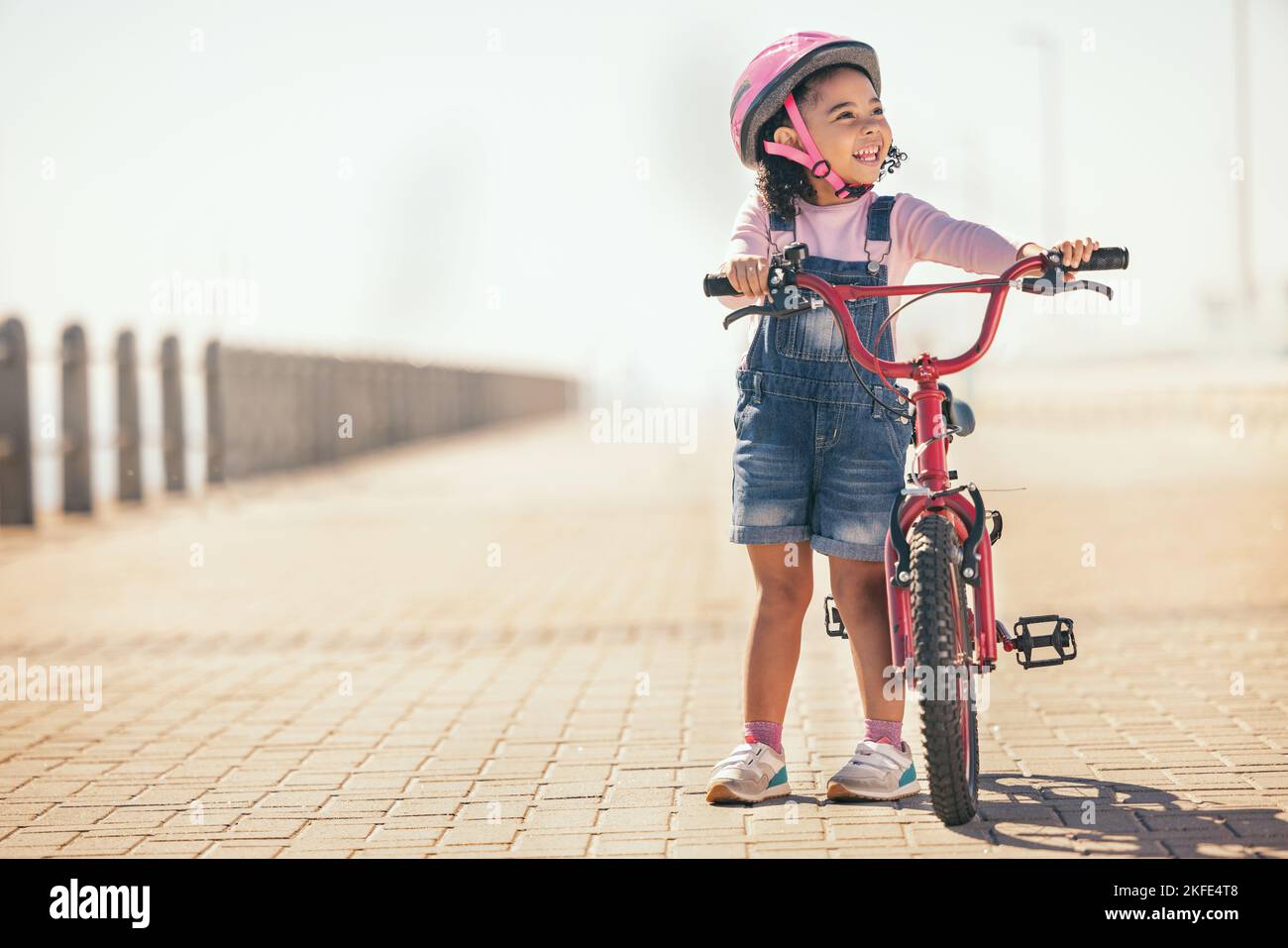 Fun, thinking and girl cycling with a bike in the city for ...