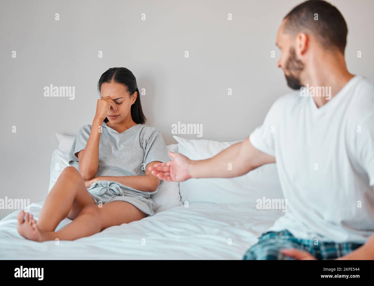 Comfort, crying and sad couple in bed after fight, argument and ...
