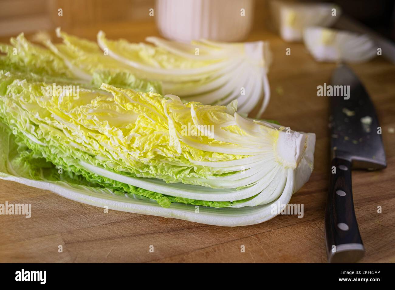 Fresh ripe sliced cabbage on wooden board with knife Stock Photo - Alamy