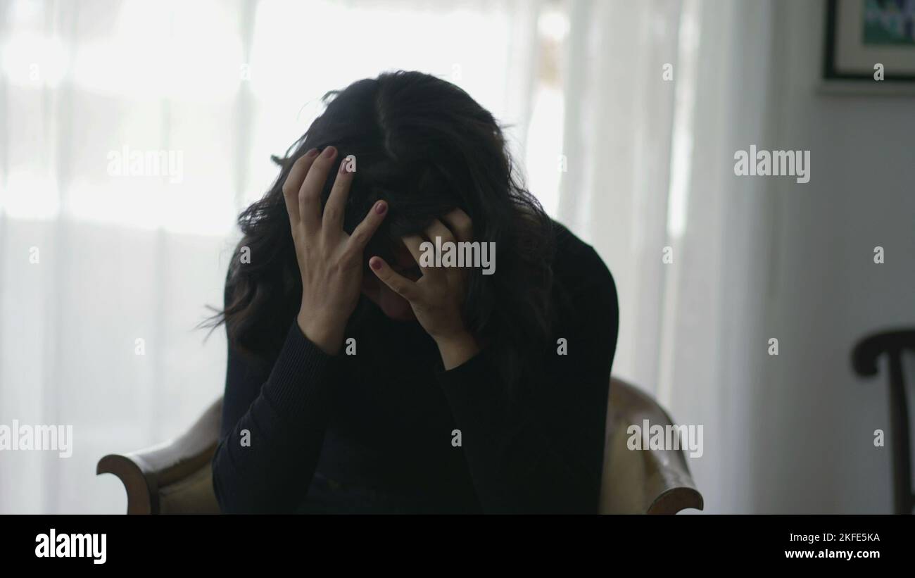 Woman covering face in shame suffering from emotional pain Stock Photo ...
